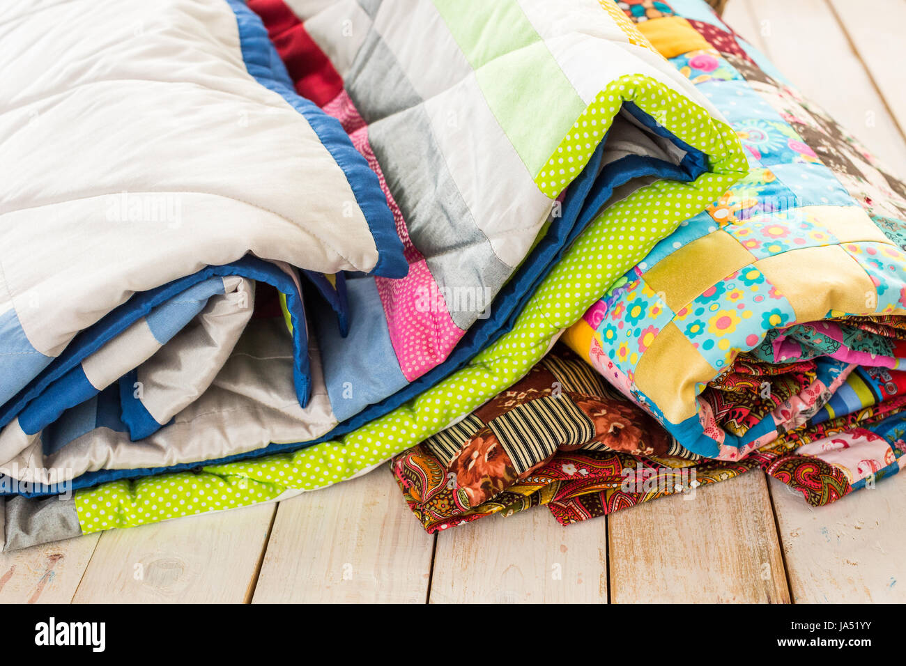 patchwork and fashion concept - close-up on beautiful colorful quilts ...