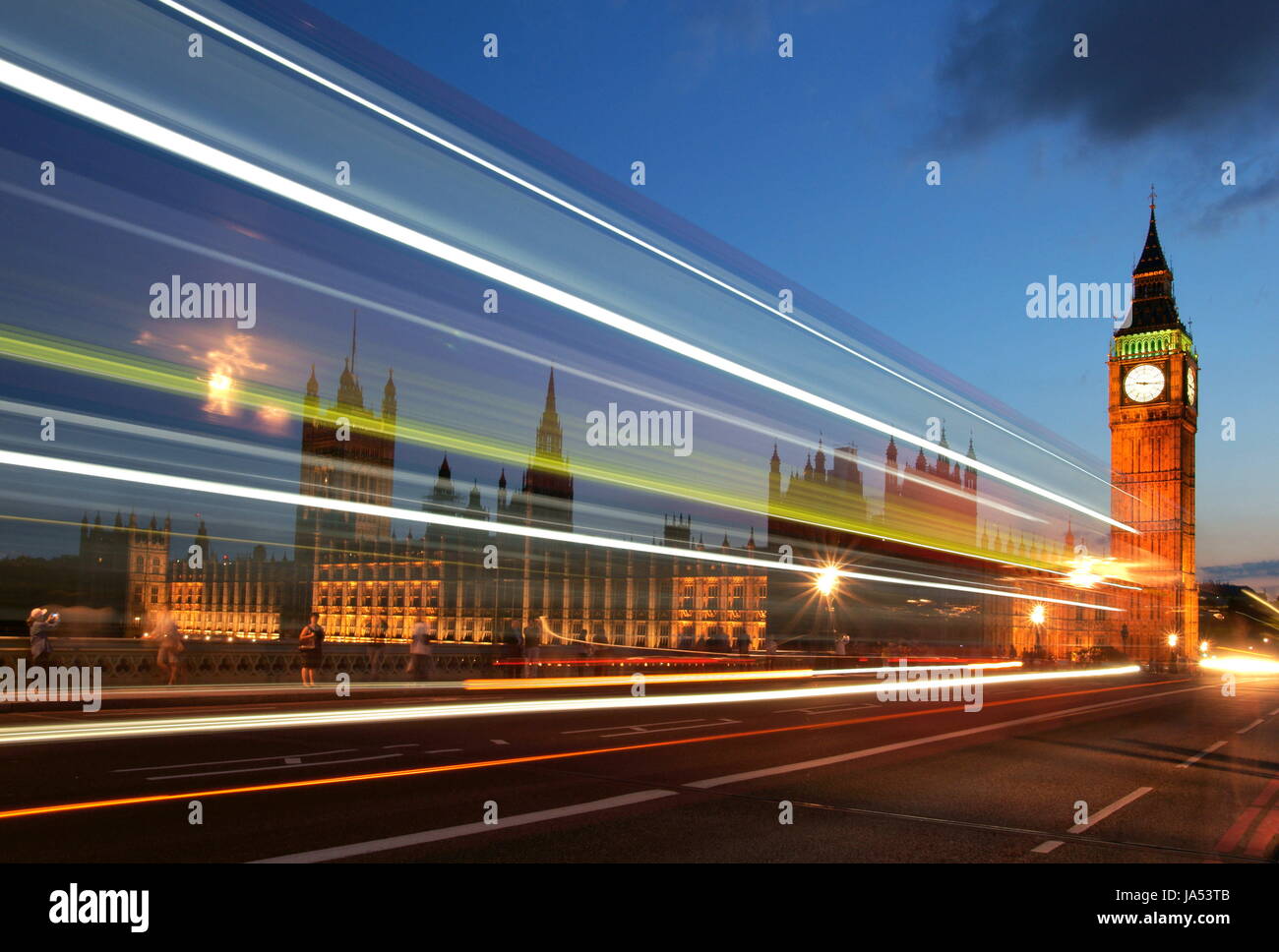 Clock tower orange illuminated in the night hi-res stock photography ...