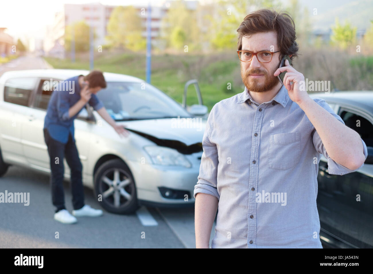 Men calling first aid after a serious car crash on the road Stock Photo ...