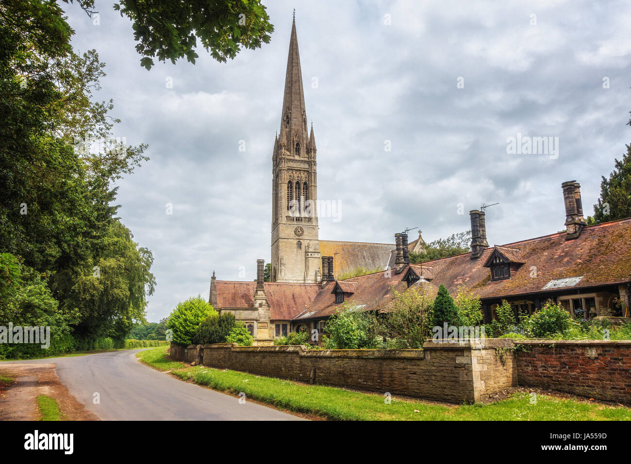 The tall spire of Victorian St Mary' Church and almshouses - quaint ...