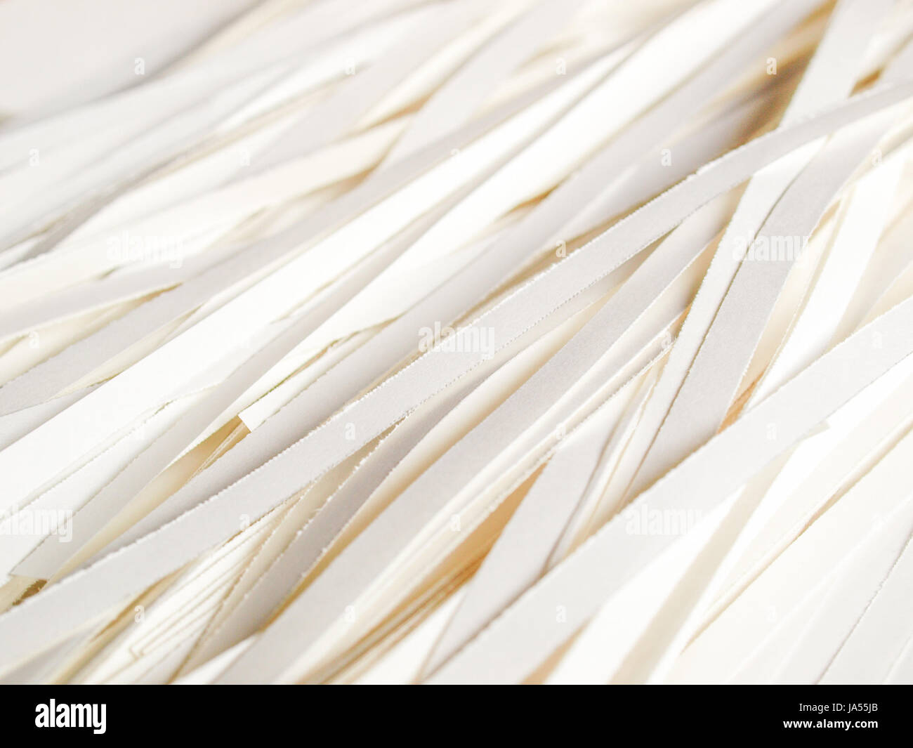 Paper documents cut into strips with a paper shredder Stock Photo - Alamy