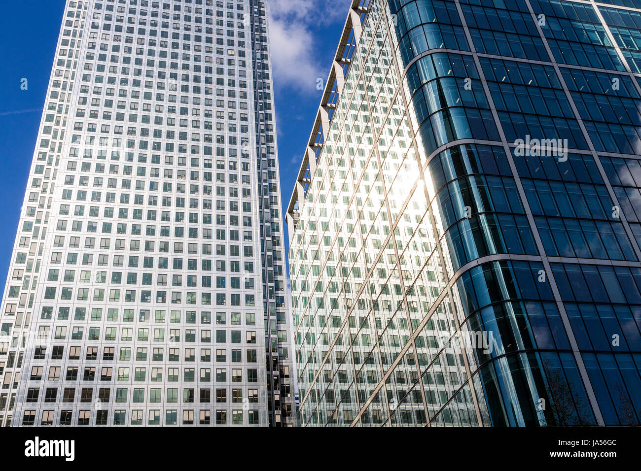 Modern glass exterior of corporate office buildings shot from a low ...