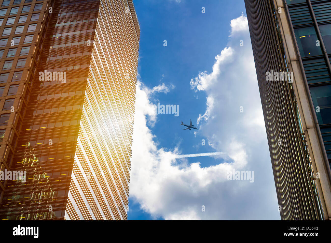Airplane silhouette with business office towers background Stock Photo ...