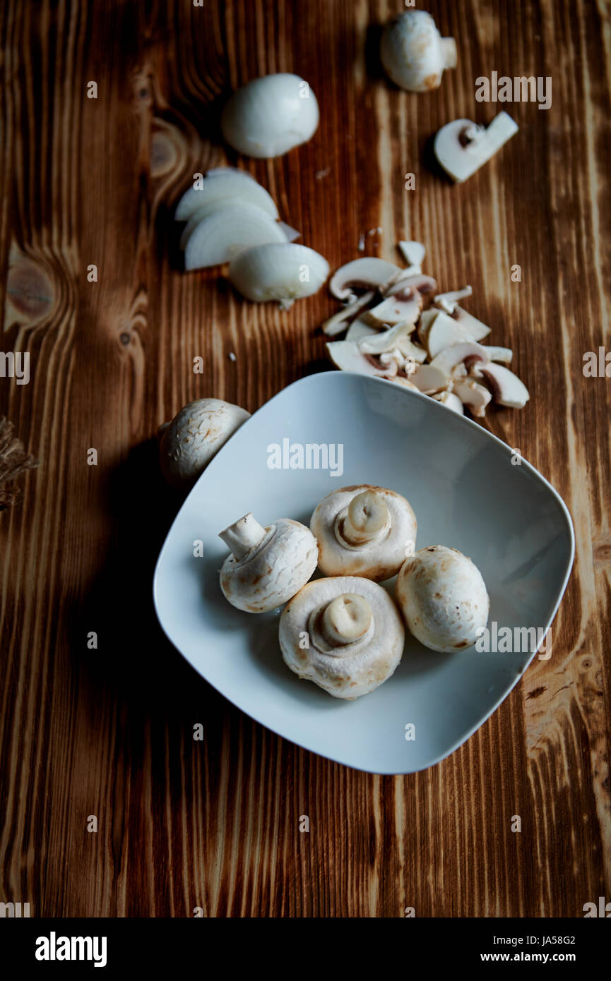 The process of cooking. mushrooms whole and sliced Stock Photo - Alamy