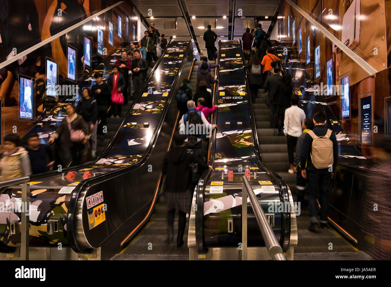Horizontal view of people on the escalators at the MTR, mass transit ...