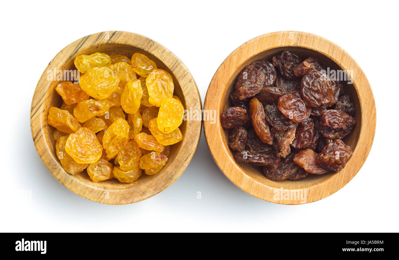 Sweet dried raisins in wooden bowl isolated on white background Stock ...