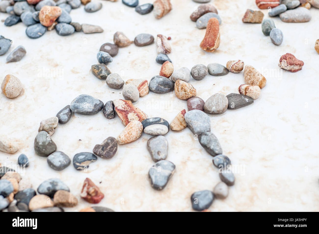 Drawings using round stones Stock Photo - Alamy