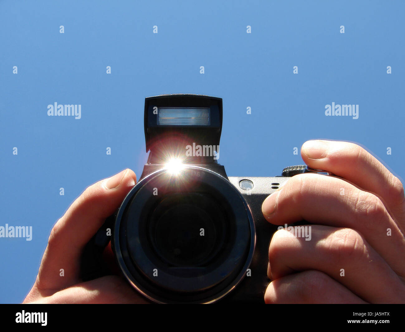 black digital camera in hands Stock Photo - Alamy