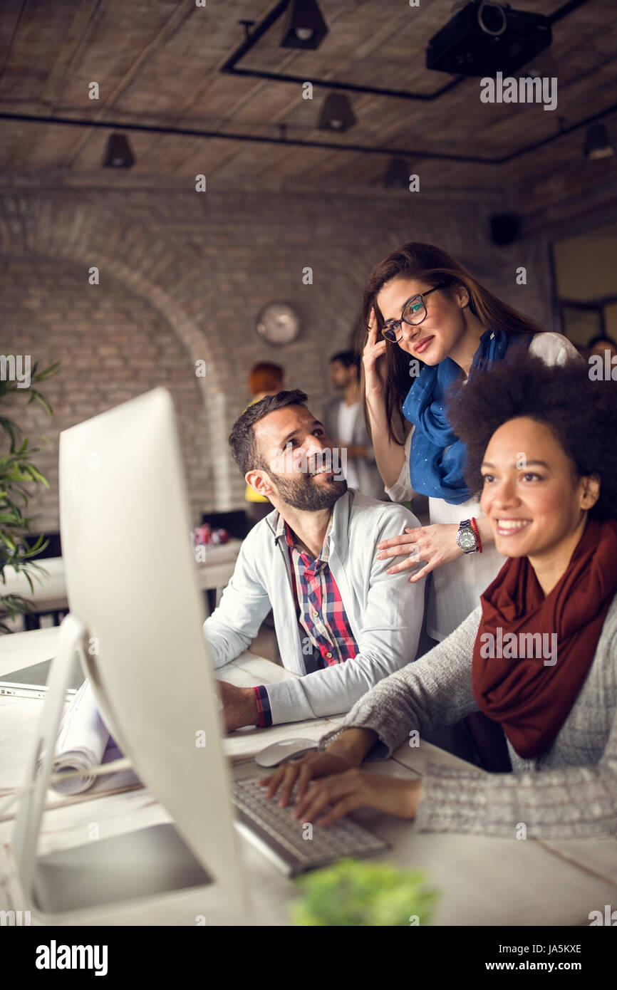 Female manager supervises work of employees in office Stock Photo - Alamy