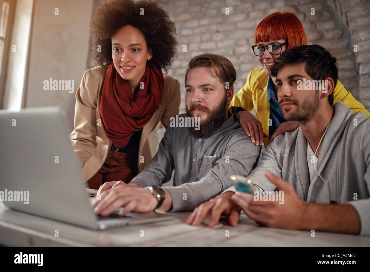 teamwork -young web designers working together Stock Photo - Alamy