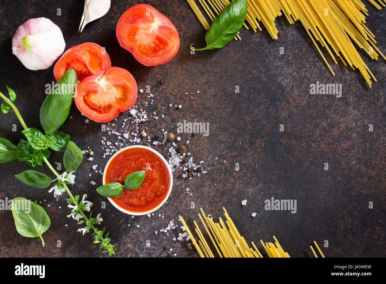 Culinary background for cooking pasta, tomato sauce, fresh herbs and ...