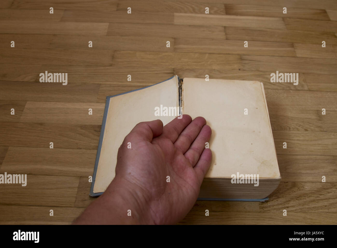 The hand points to an open book Stock Photo - Alamy