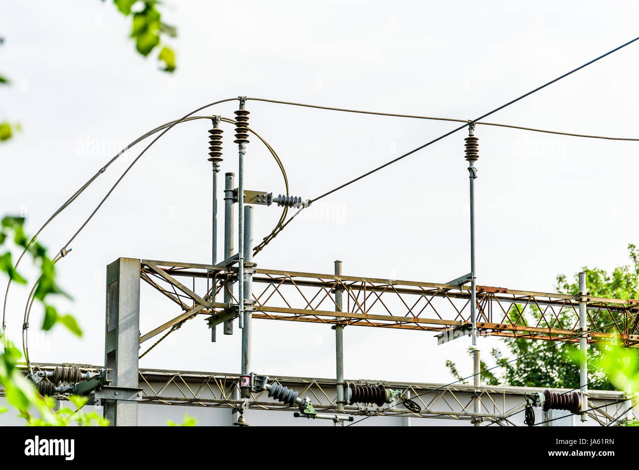 Metal high voltage electric supply cables over railway Stock Photo - Alamy
