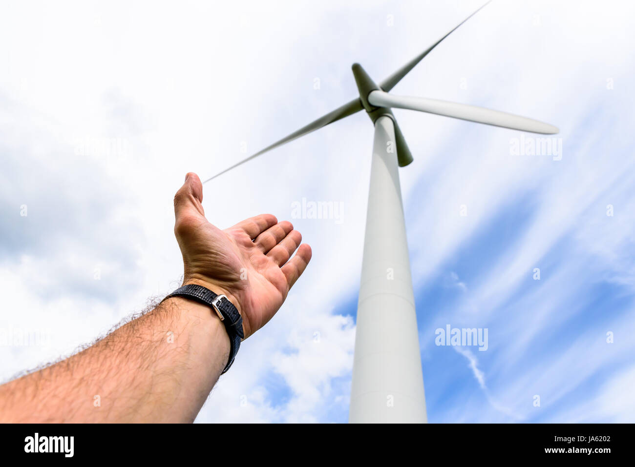 Human hand aiming to wind power turbines generate electricity Stock ...