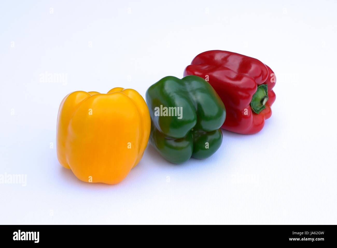 Three-color pepper on a white background Stock Photo - Alamy