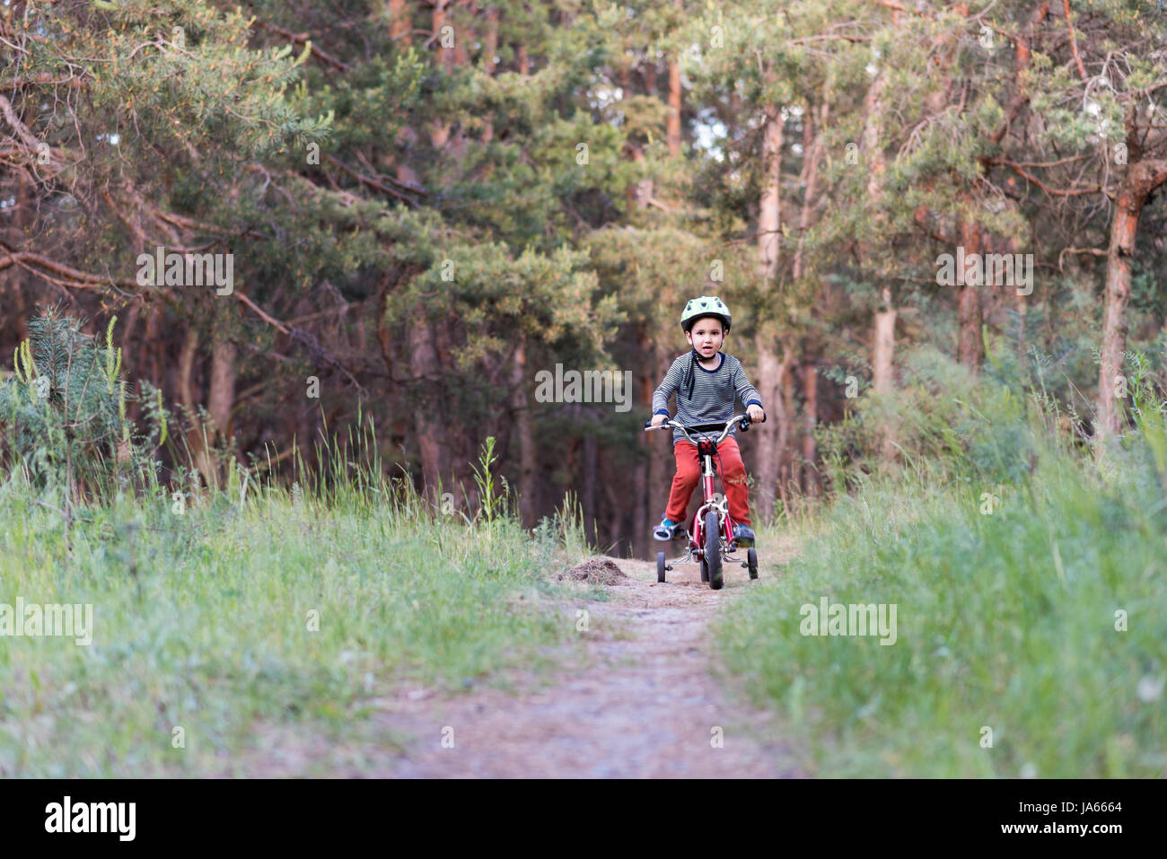 Child riding a bicycle Stock Photo - Alamy