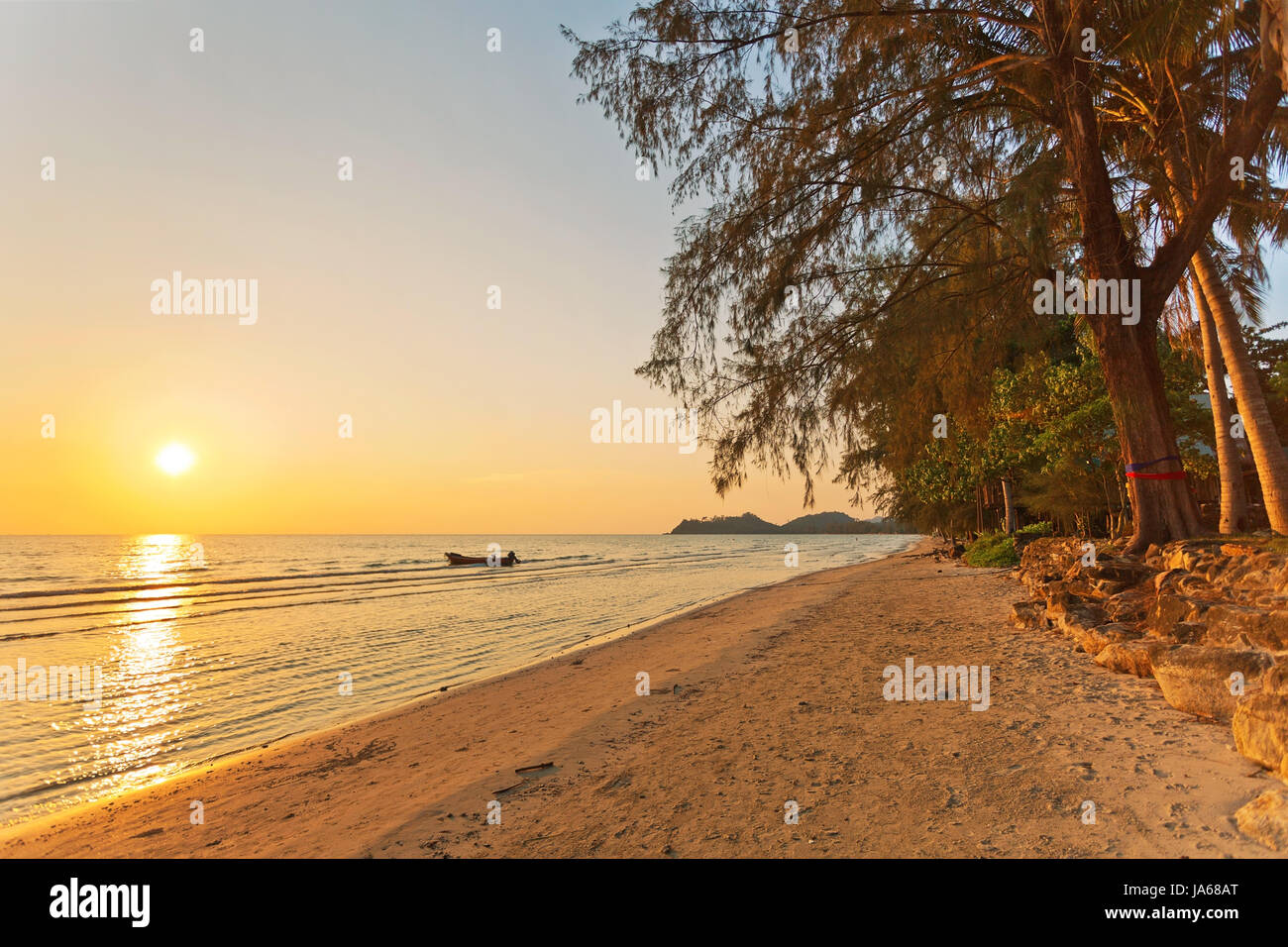 Tropical beach in ebb time on sunset background Stock Photo - Alamy