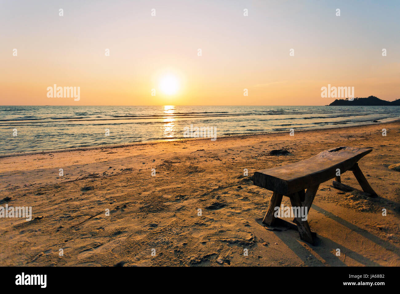 wooden bench on the sandy beach with views on sunset Stock Photo - Alamy