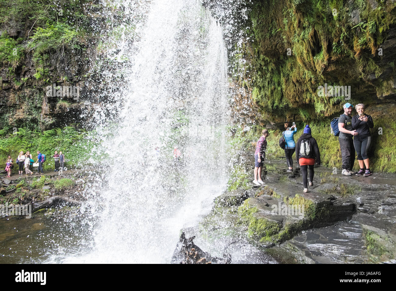 People,hiking,walk,behind,beneath,waterfall,Sgwd yr Eira,Waterfall of ...