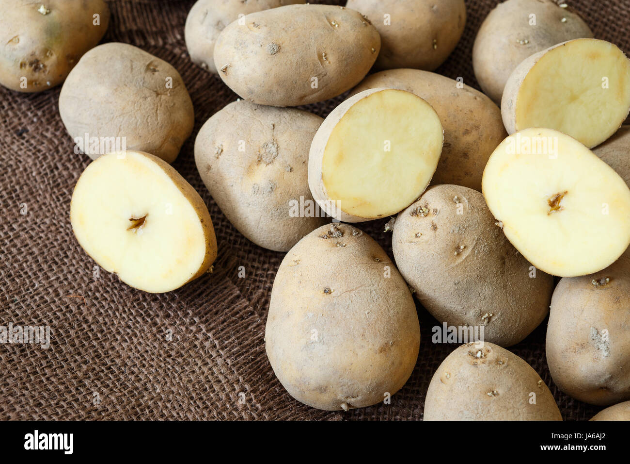 Old potato on brown background Stock Photo - Alamy
