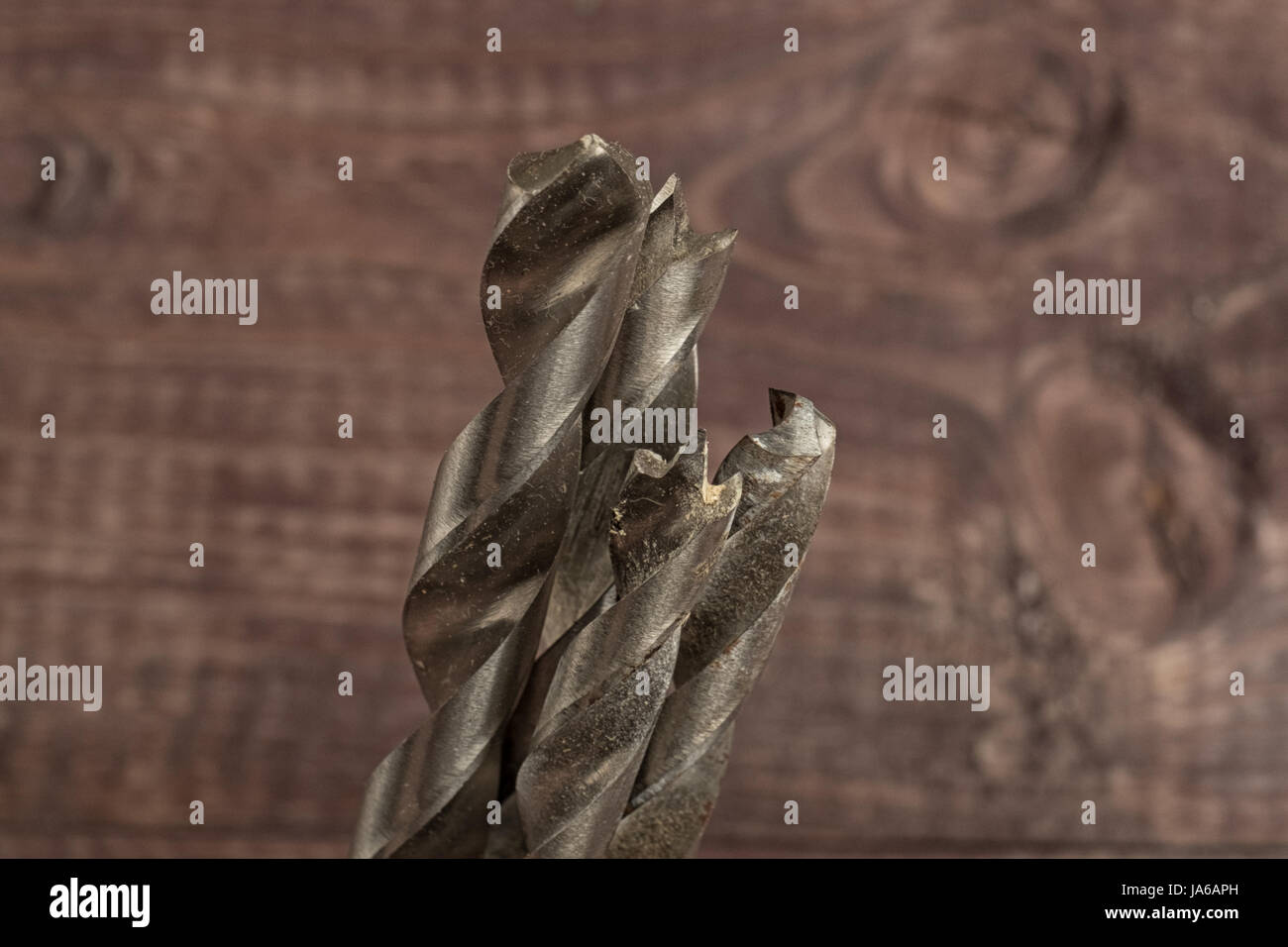 Drill bit on wooden table for drilling work Stock Photo - Alamy