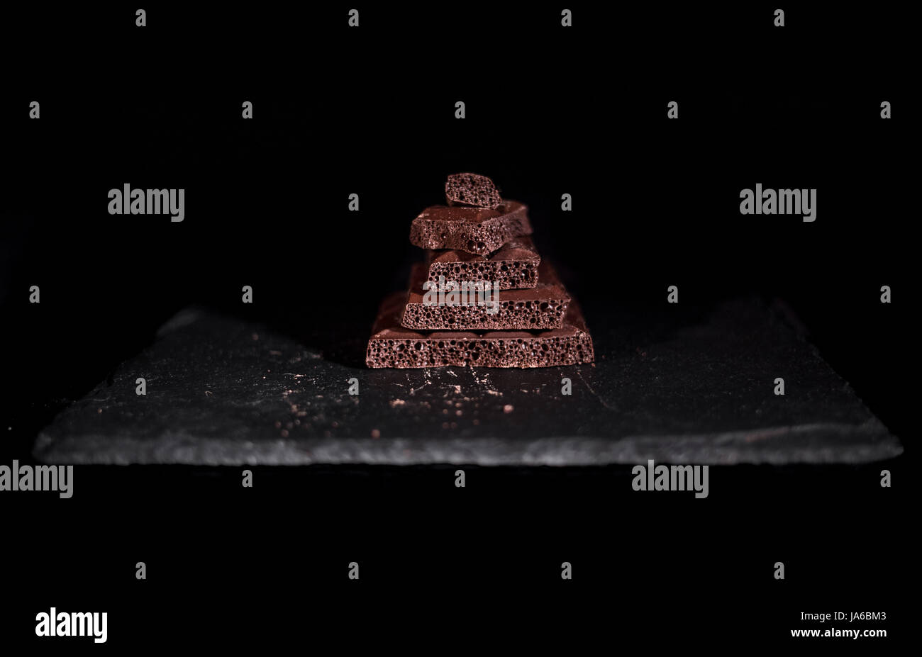 Stack of black pore chocolate Stock Photo - Alamy