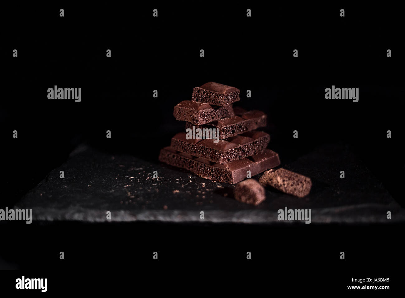 Stack of black pore chocolate Stock Photo - Alamy
