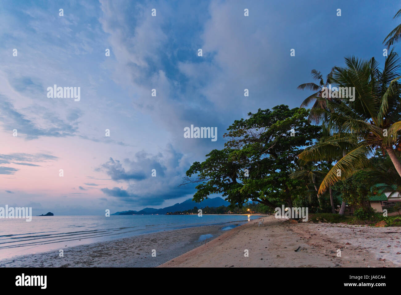 Tropical beach in ebb time after sunset Stock Photo - Alamy