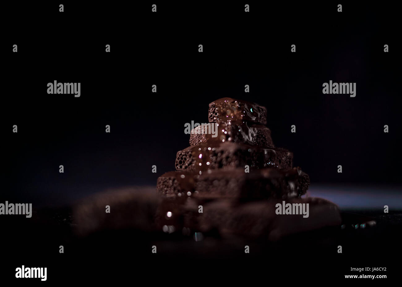 Stack of black pore chocolate Stock Photo - Alamy