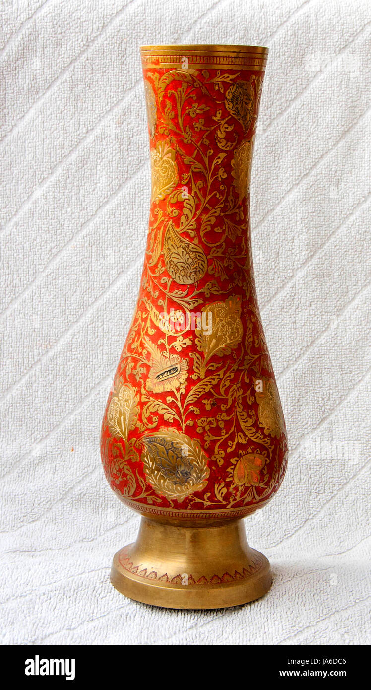 Brass vase with beautiful engravings on it and painted in red color ...