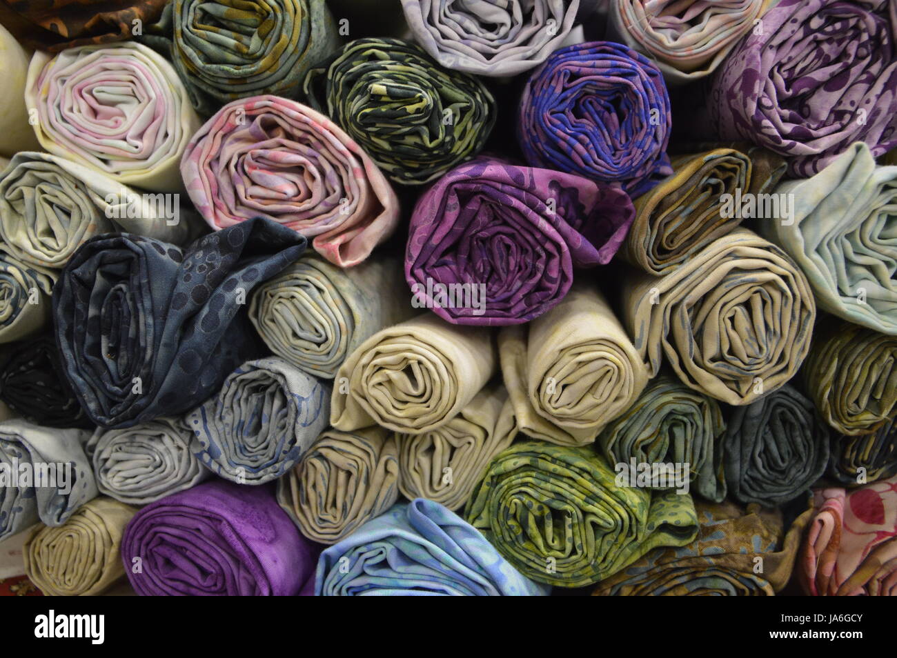 A stack of rolled fabric for sewing or quilting Stock Photo - Alamy
