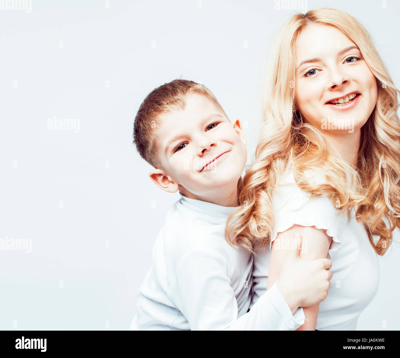 young modern blond curly mother with cute son together happy smiling ...