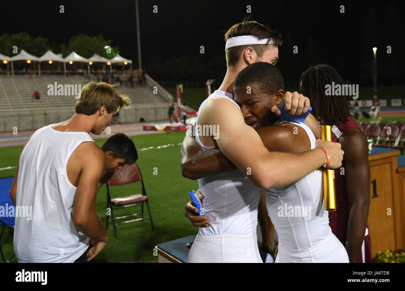 Members of the Long Beach Wilson 4 x 400m relay react after placing ...