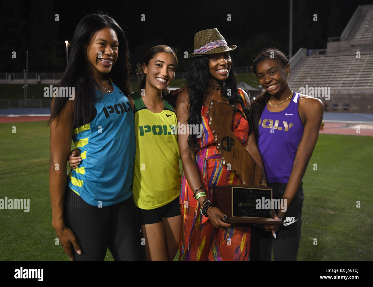 Members of the Long Beach Poly girls team and coach Cryrstal Irving ...