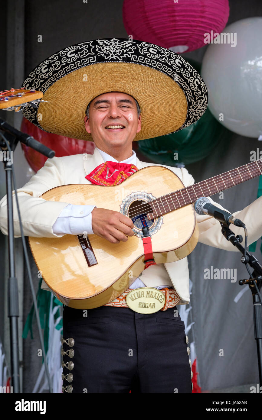 Live music. Male Mexican mariachi acoustic guitar player wearing a ...