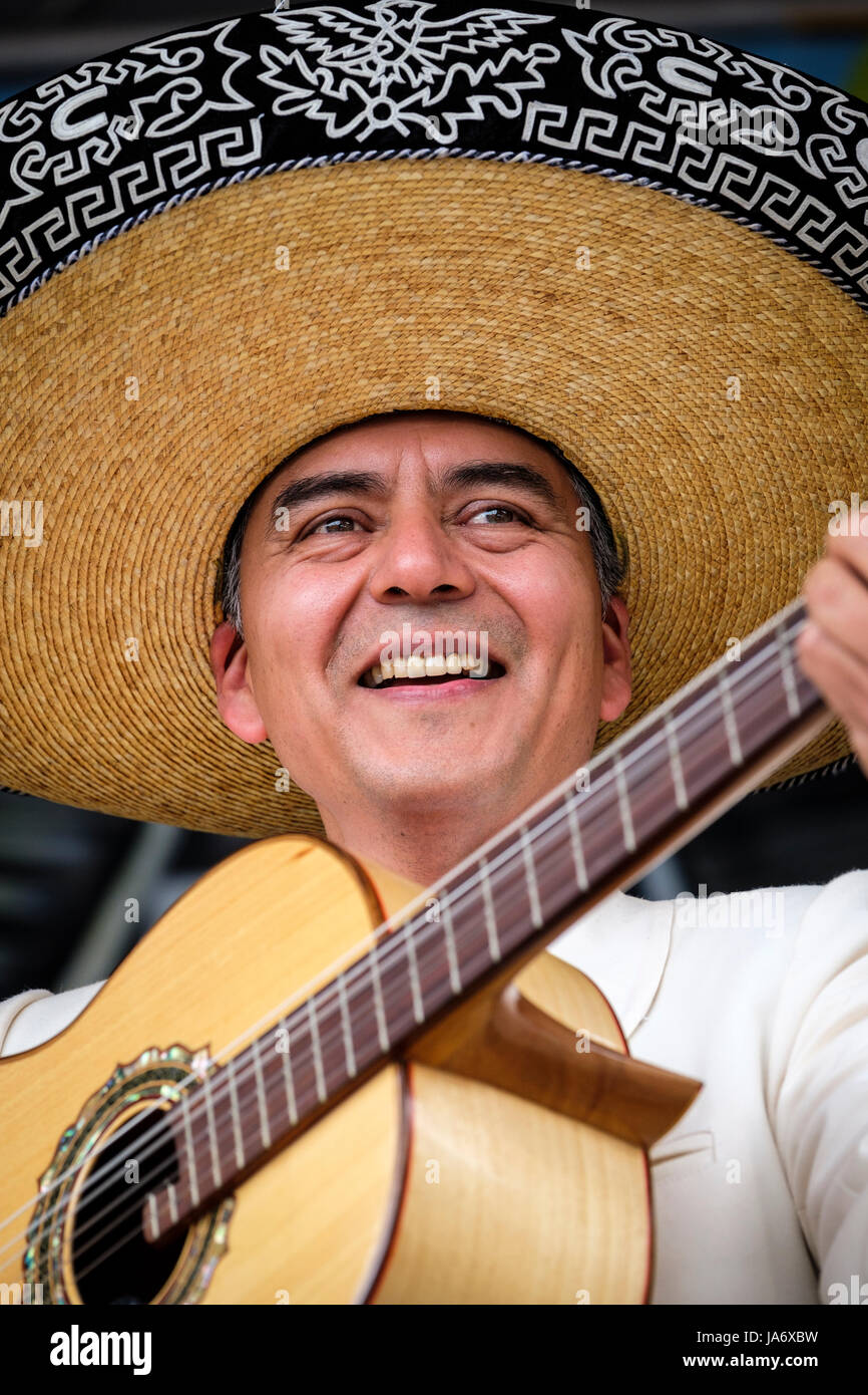 Live music. Male Mexican mariachi acoustic guitar player wearing a ...