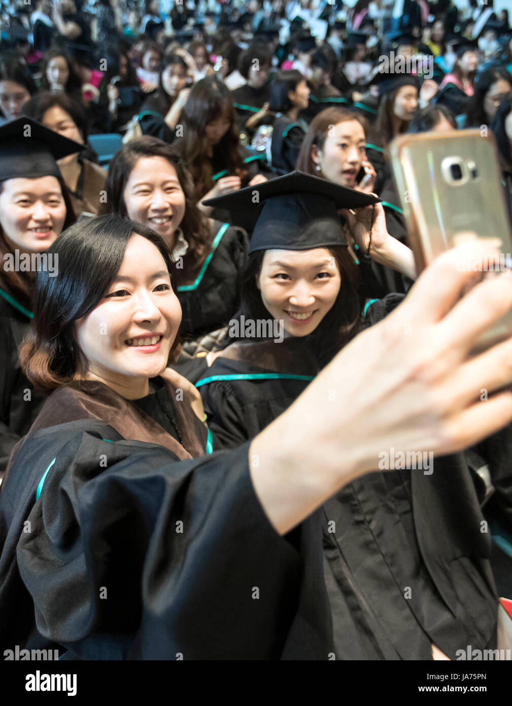 Graduation Students take a selfie at a graduation ceremony at Ewha ...