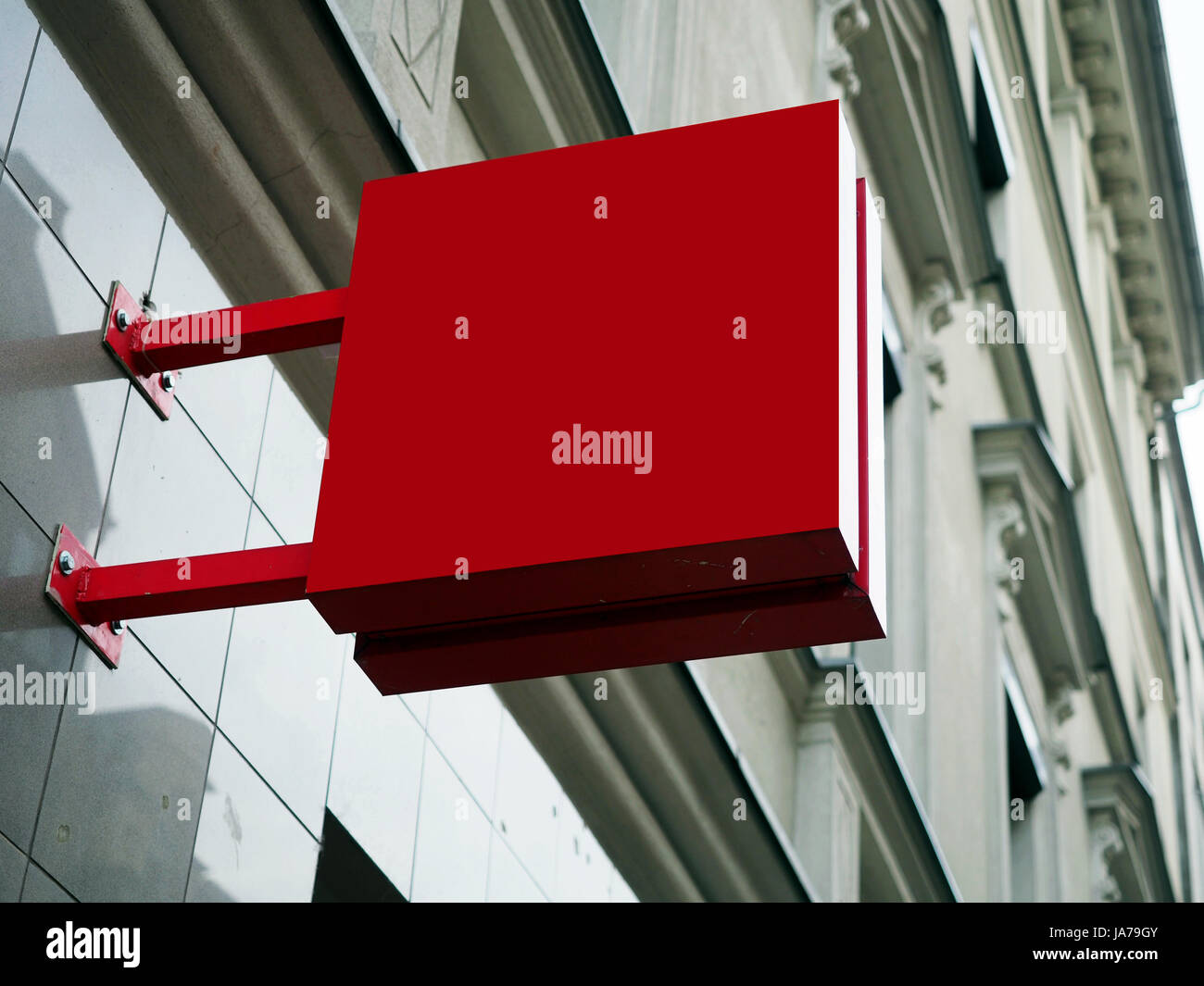 Signboard side view of empty red mock up signage with modern city wall ...