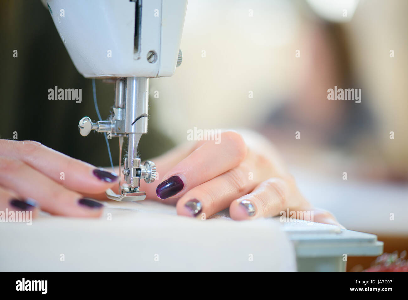 womens hands with sewing machine Stock Photo - Alamy