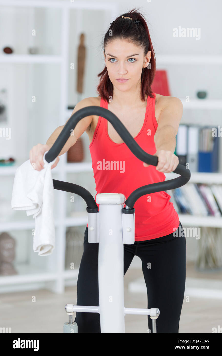 sporty determined young woman training on step machine Stock Photo - Alamy
