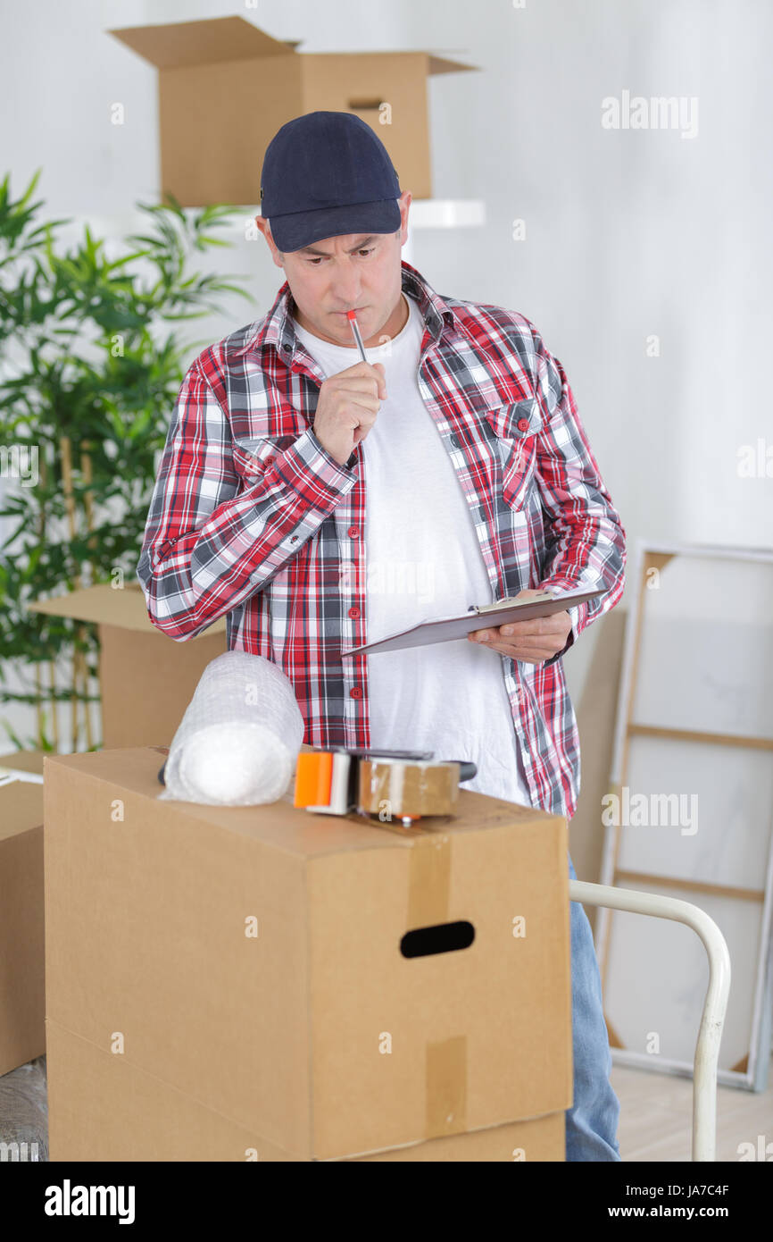 male worker checking a box Stock Photo - Alamy