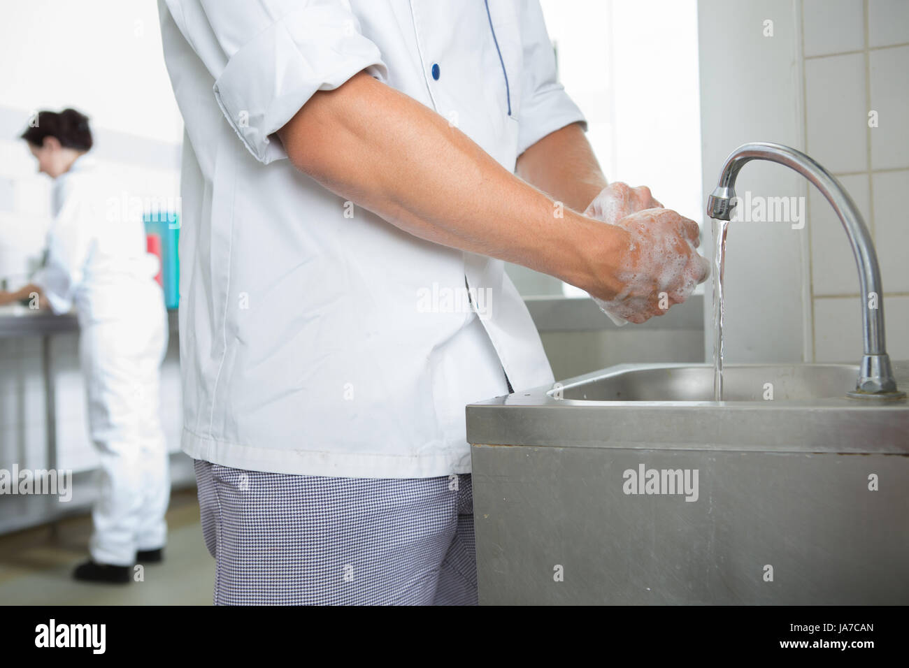 Male cook washing hands Stock Photo - Alamy
