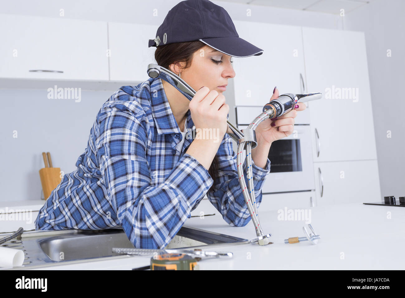 plumber fixing tap with adjustable wrench Stock Photo - Alamy