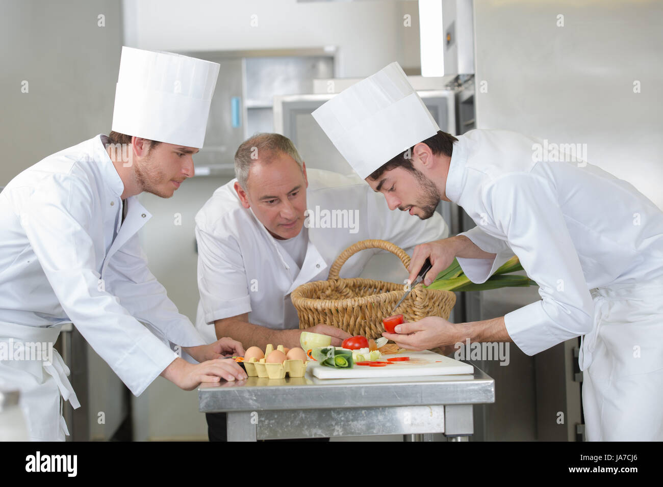 Apprentice chef preparing a tomato Stock Photo - Alamy