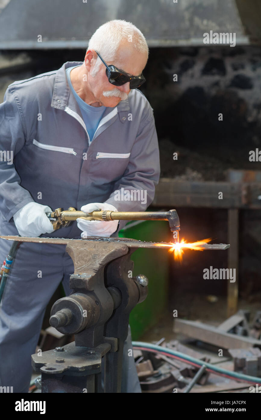 senior metal worker welding joint steel Stock Photo - Alamy