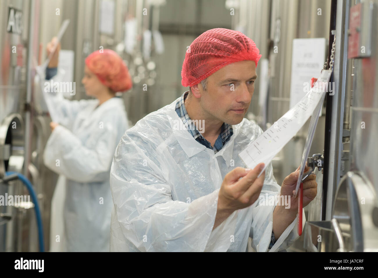 Male worker checking vat Stock Photo - Alamy
