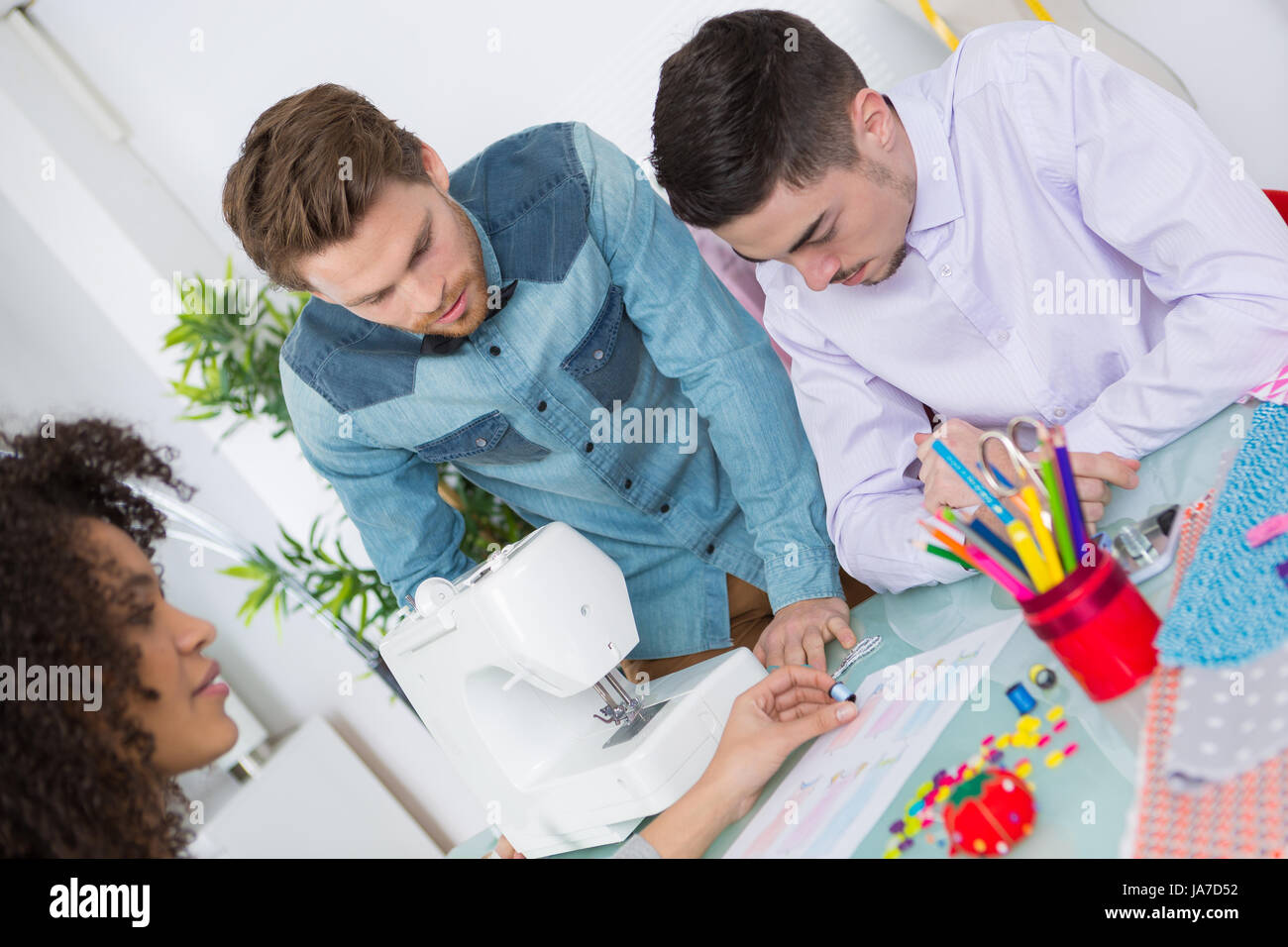 young woman stitching fabric using a sewing machine Stock Photo - Alamy