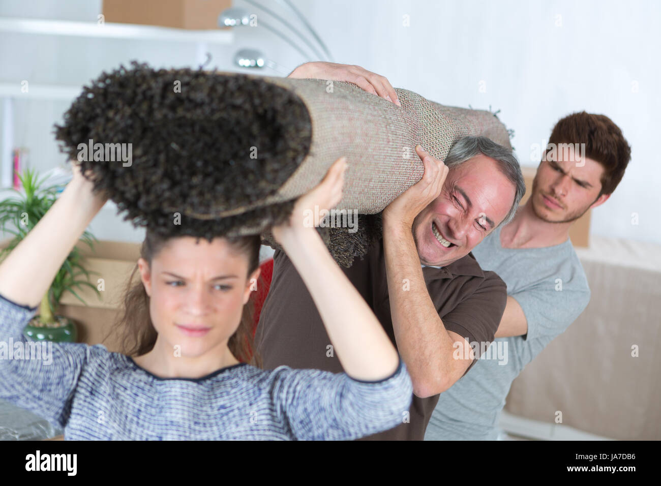 young couple and father helping them to move out Stock Photo - Alamy