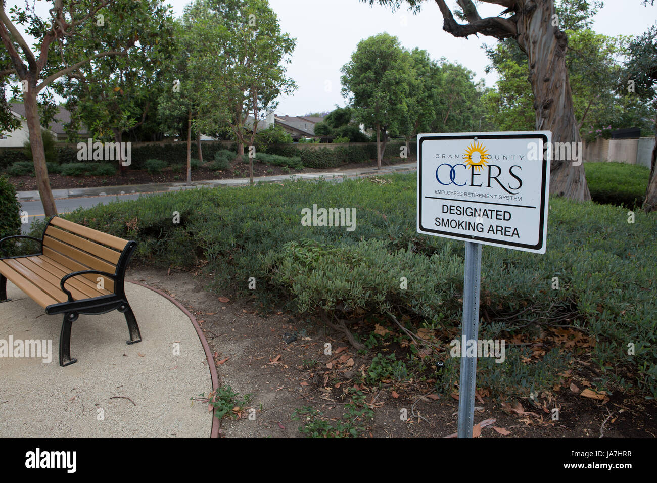 A bench seat for smokers in a designated smoking area outside a office ...