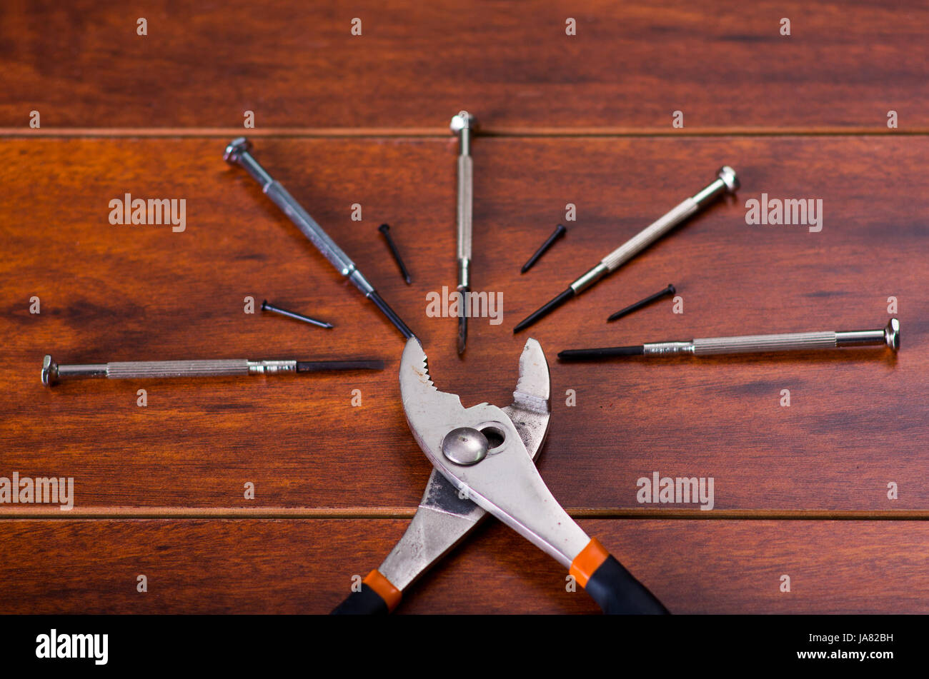 Pliers and construction tools on wooden background Stock Photo - Alamy